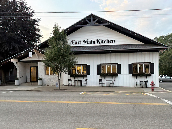 Crisp white siding and black accents give this place a modern farmhouse vibe that promises updated classics done right.
