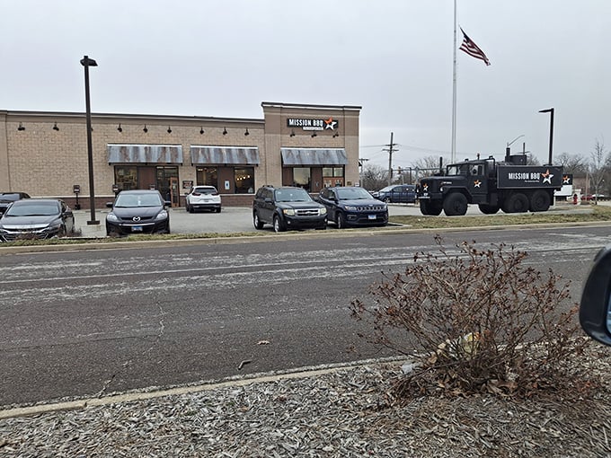 MISSION BBQ's patriotic presence extends beyond the building to their custom military-style vehicle parked proudly outside.