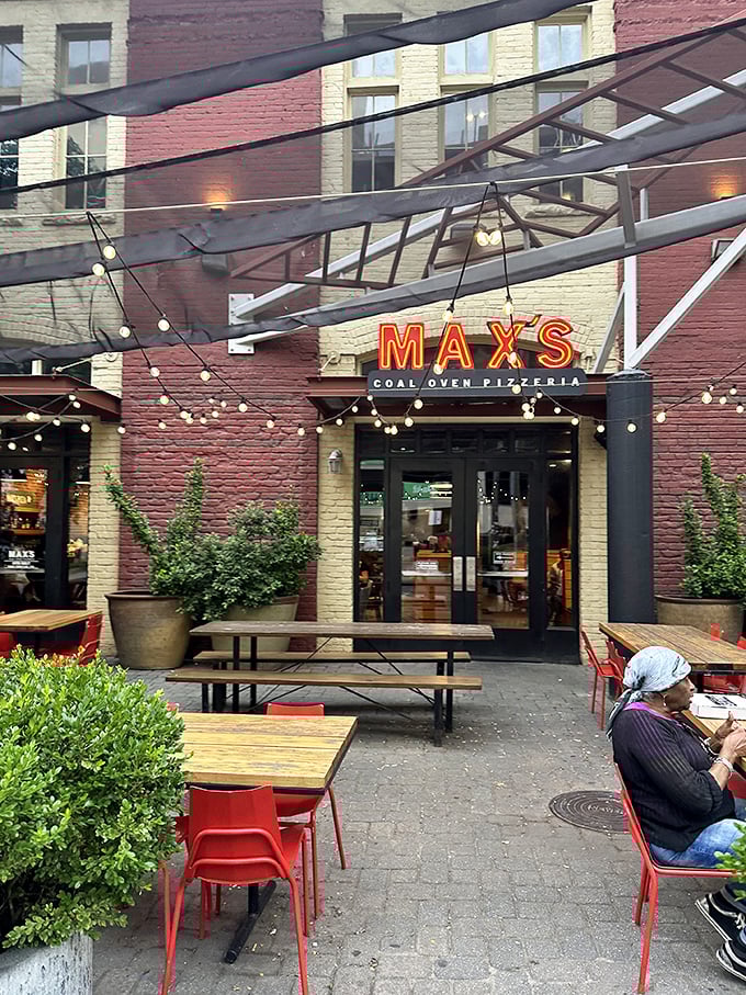 Max's outdoor seating transforms into an urban oasis where coal-fired magic happens under twinkling lights.