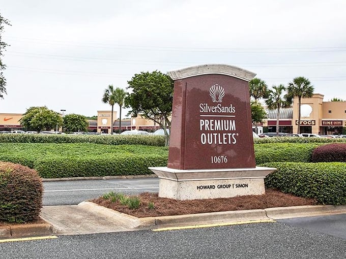 Silver Sands' welcoming sign promises retail therapy just minutes from the emerald waters that give this coast its name.