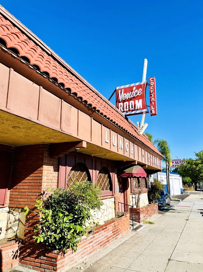The Venice Room's retro sign promises old-school charm. This pink building houses one of California's most unique dining experiences &ndash; you become the chef!