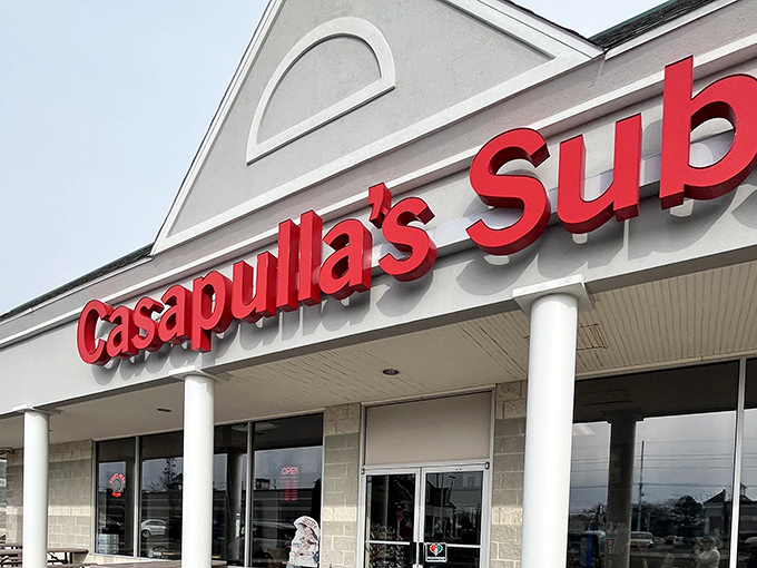 The red Casapulla's sign pops against the clean white exterior &ndash; a colorful promise of the flavor explosion waiting inside.