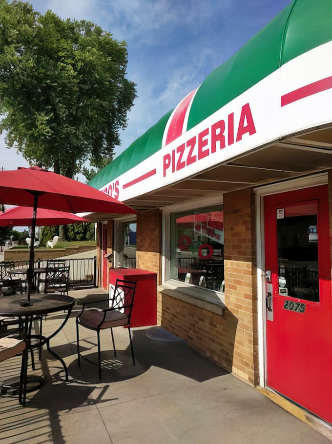 Red door, outdoor tables, and that classic green-white-red awning – DeCheco's creates the perfect setting for pizza perfection in any season.