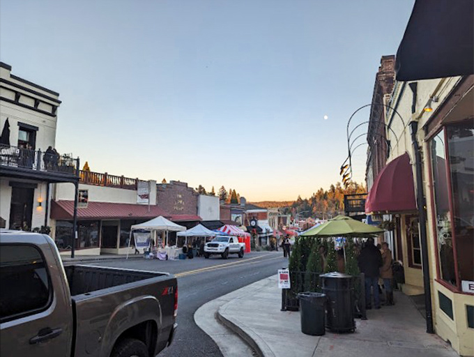 Evening settles over Grass Valley's main street, transforming storefronts into a postcard-perfect scene. Norman Rockwell would approve!