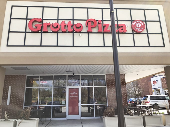 The distinctive Grotto Pizza sign promises their famous swirl pattern inside &ndash; pizza with a signature as unique as yours.