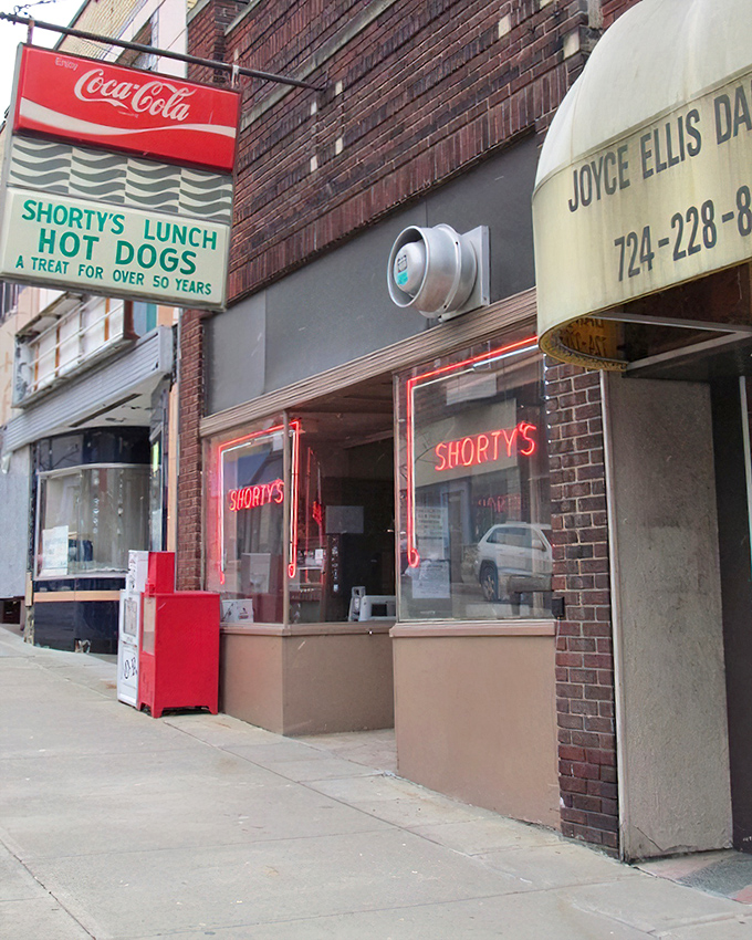 The classic neon signs of Shorty's glow like beacons for hot dog lovers – guiding hungry patrons to this time-honored establishment for over 50 years.