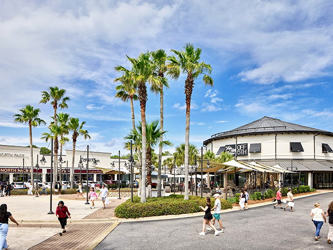 Palm trees sway as shoppers play at Silver Sands, where outlet shopping comes with a refreshing side of coastal breeze.