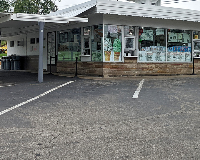 The classic white exterior of Dalton Dari-ette stands like a time capsule of Americana, complete with hand-painted ice cream cone signage that beckons from the roadside.