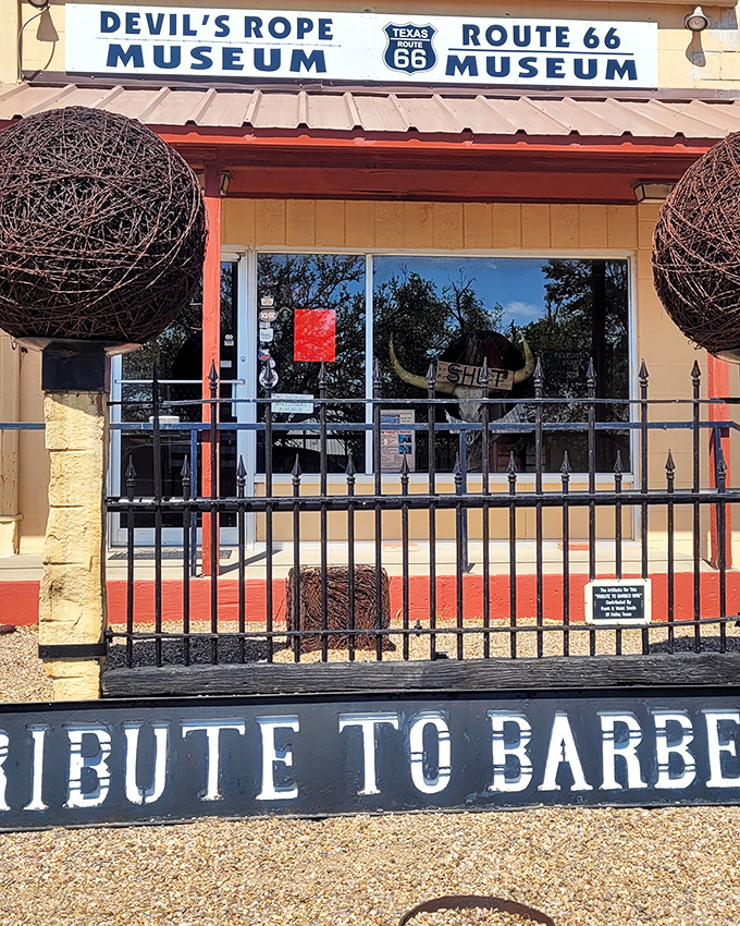 "DEVIL'S ROPE MUSEUM" and "ROUTE 66 MUSEUM" share billing on the sign, a perfect pairing of American innovations that shaped the West in entirely different ways.