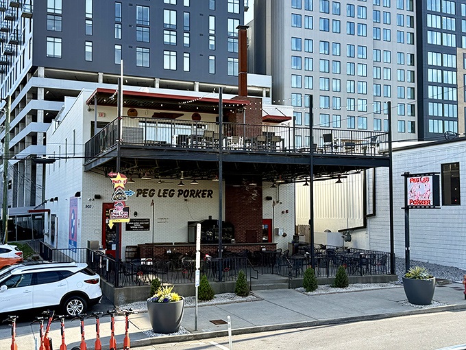 The urban oasis of smoke and flavor stands proudly in Nashville's Gulch neighborhood, its iconic pig sign beckoning hungry pilgrims from near and far.