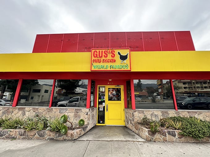 The red and yellow facade of Gus's isn't just eye-catching&mdash;it's a beacon of hope for fried chicken enthusiasts everywhere. That yellow door promises delicious secrets within.