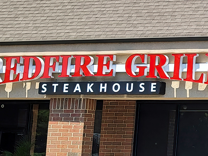 The bold red signage of Redfire Grill & Steakhouse stands out like a culinary lighthouse, beckoning hungry travelers to drop anchor in Hockessin.