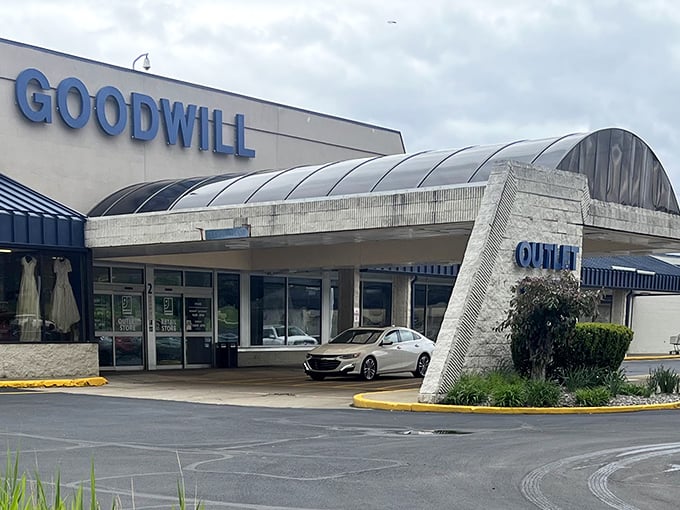 The distinctive blue "OUTLET" sign beckons bargain hunters like a retail lighthouse, promising treasures within this unassuming Akron landmark.