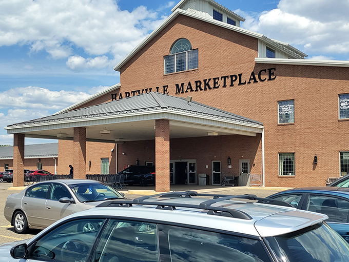 The brick facade of Hartville MarketPlace stands like a cathedral to commerce, promising treasures within that big box stores can only dream about.