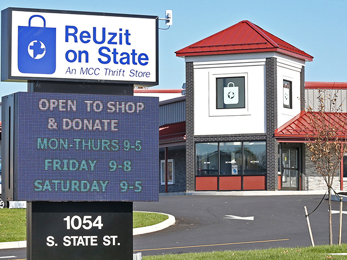 The iconic blue sign of ReUzit on State stands like a beacon of bargain-hunting hope against Ephrata's sky, promising treasures within those brick walls.