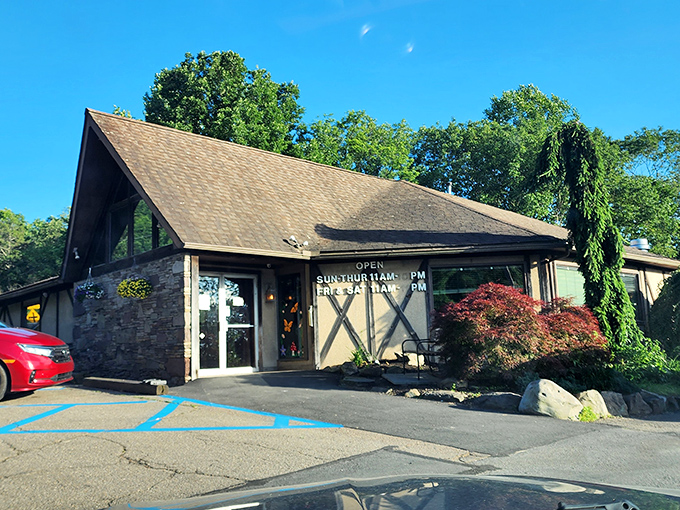 The A-frame charm of The Fireplace Restaurant stands like a rustic beacon for hungry travelers. Those barn-style X's aren't just for show&mdash;they're signaling "X marks the spot" for prime rib treasure.
