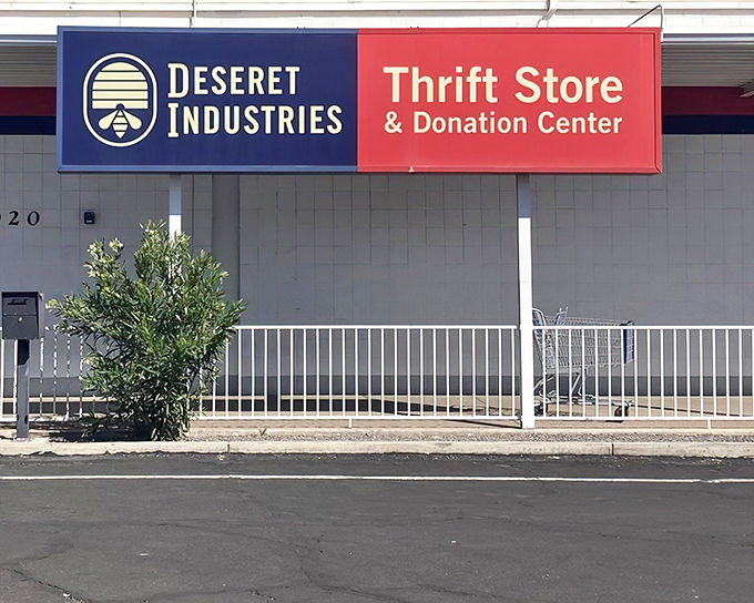 The iconic blue and red sign of Deseret Industries stands like a beacon for bargain hunters across Mesa, promising treasures waiting to be discovered inside.