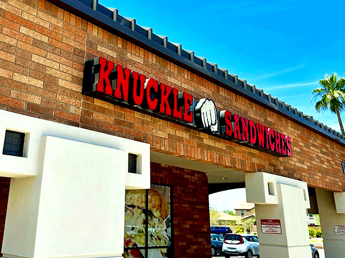 The bold red signage with that iconic fist logo promises a flavor punch that lives up to the name. No fancy frills, just serious sandwich business.
