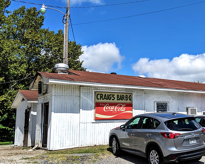 That red trim and gravel parking lot? It's the universal signal in the South that smoke-kissed perfection awaits inside.