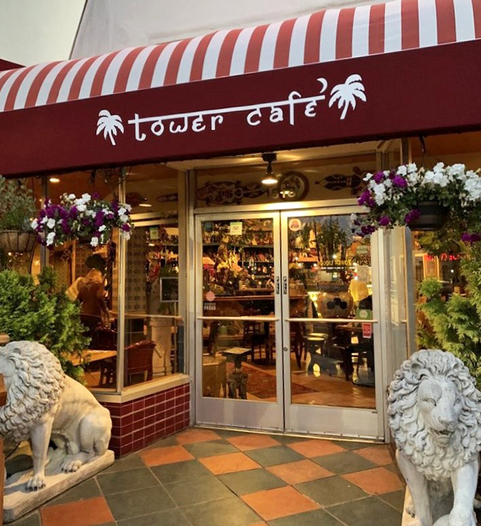 Stone lions stand guard at Tower Cafe's entrance, as if saying "Prepare your taste buds for an adventure worth roaring about."