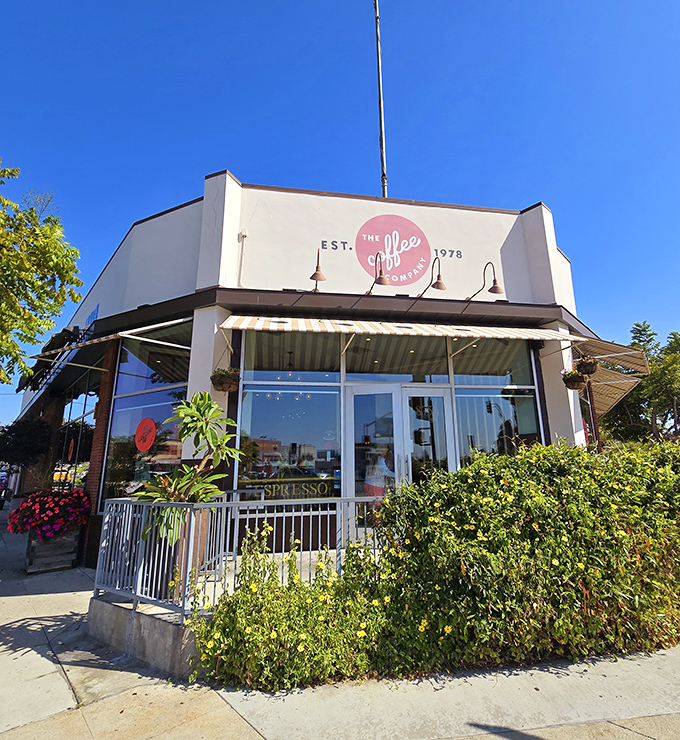 The Coffee Company's corner location basks in California sunshine, its iconic red logo promising morning salvation to caffeine-seekers and breakfast enthusiasts alike.