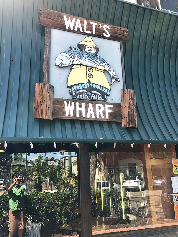 Walt's Wharf stands proudly on Main Street in Seal Beach, its iconic green awning and fisherman sign beckoning seafood lovers like a lighthouse to hungry sailors.