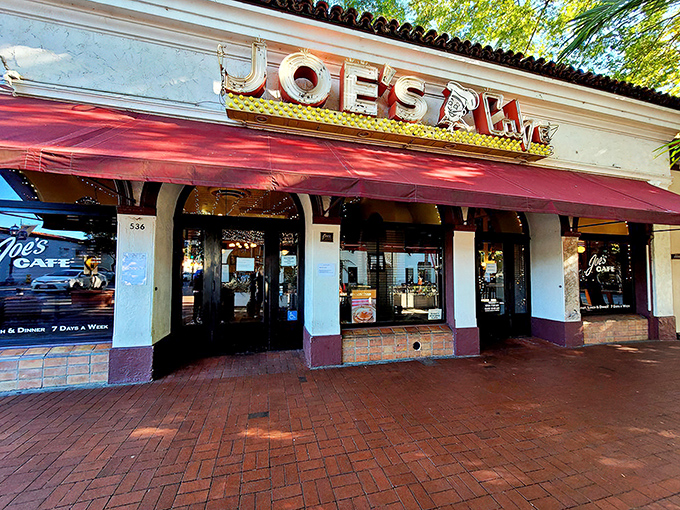 The iconic red awning of Joe's Caf&eacute; beckons hungry travelers like a culinary lighthouse on Santa Barbara's State Street.