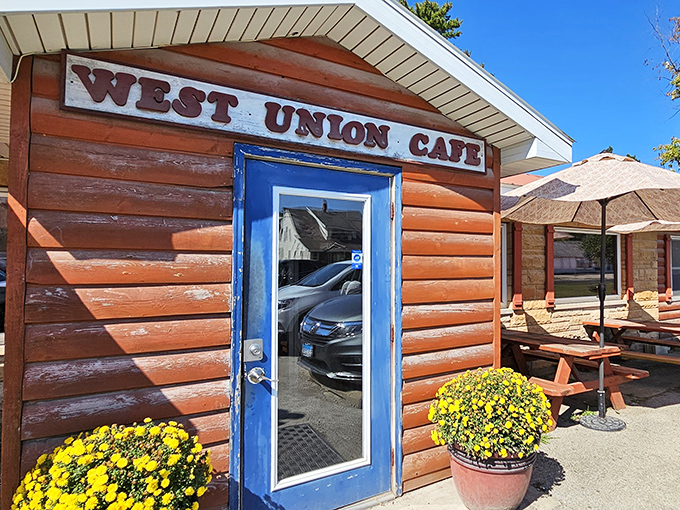 The rustic log cabin exterior of West Union Cafe welcomes hungry travelers with its bright blue door and cheerful yellow mums&mdash;rural Illinois' version of a culinary red carpet.