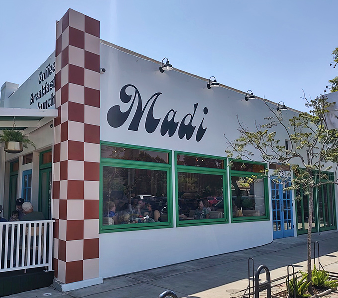 Madi's iconic red-and-white checkered corner facade stands out in Pacific Beach like a culinary lighthouse guiding hungry souls to breakfast nirvana.