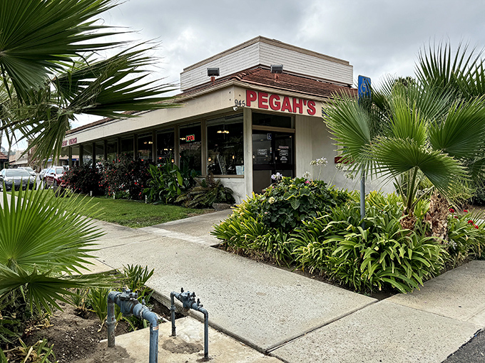 Palm fronds stand guard like culinary sentinels outside Pegah's Kitchen, where the unassuming exterior hides breakfast treasures waiting to be discovered.