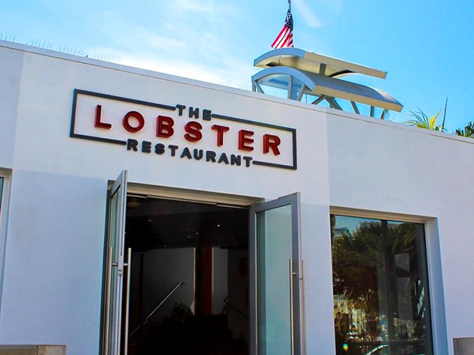 The iconic white facade of The Lobster stands like a beacon at the entrance to Santa Monica Pier, promising seafood treasures within.