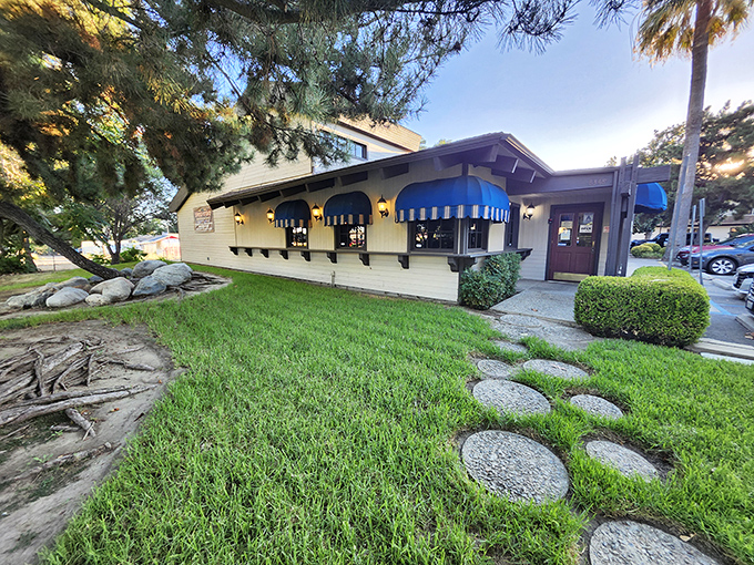 The unassuming exterior of Steer N' Stein, with its charming blue awnings, proves that culinary treasures often hide in plain sight.