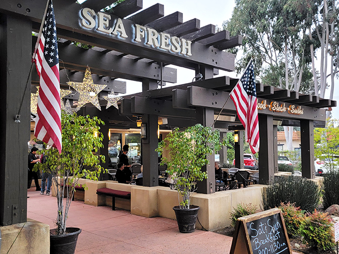 The welcoming pergola at Sea Fresh beckons like an old friend, promising seafood treasures under that rustic wooden frame and California sunshine.