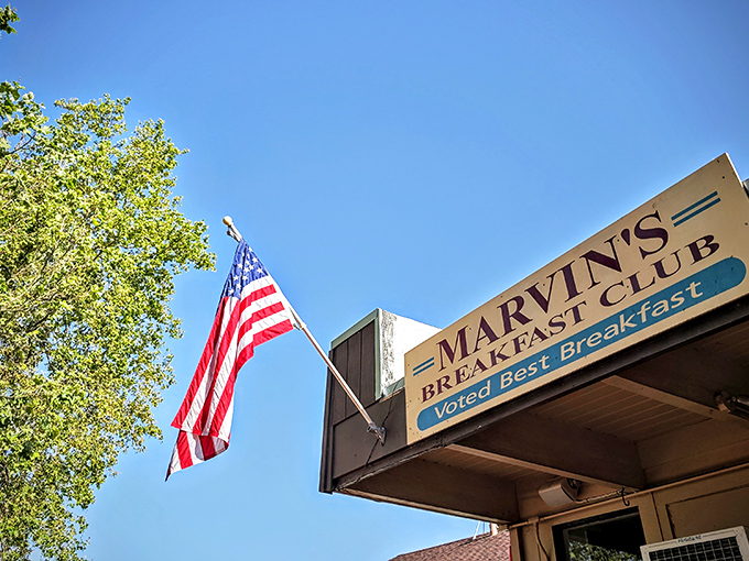 The American flag waves proudly above Marvin's Breakfast Club, a humble storefront that's earned its "Voted Best Breakfast" badge through years of morning meal mastery.