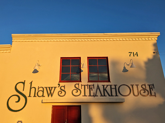 The white facade with bold green lettering and red doors isn't just a restaurant entrance&mdash;it's a portal to California's beef heritage.
