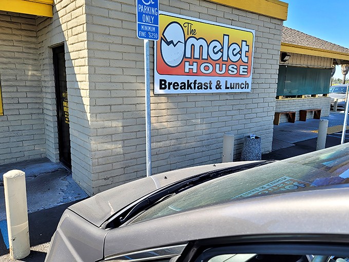 The unassuming exterior of The Omelet House proves that culinary treasures often hide behind the simplest facades. That cheerful egg mascot knows what's up!