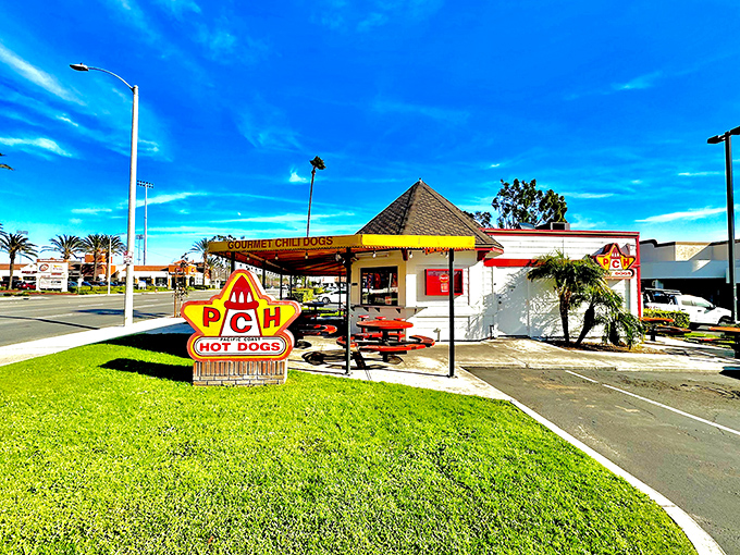 Where classic meets California&mdash;PCH's iconic yellow sign promises roadside salvation in hot dog form. Palm trees and blue skies included at no extra charge.