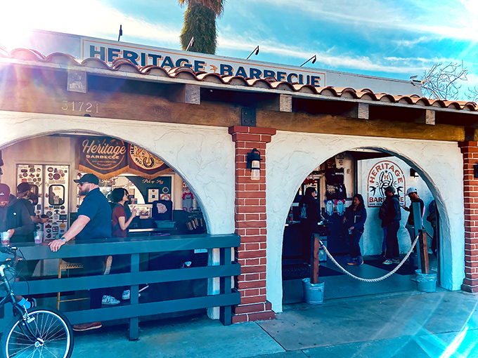 The Spanish-style facade of Heritage Barbecue welcomes hungry pilgrims with the promise of smoky salvation. That line? Consider it the appetizer to your meat feast.