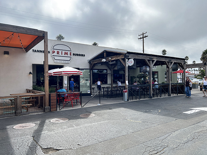 The unassuming exterior of Tanner's Prime Burgers belies the flavor explosion waiting inside. California sunshine and red umbrellas welcome hungry pilgrims to this Oceanside sanctuary.