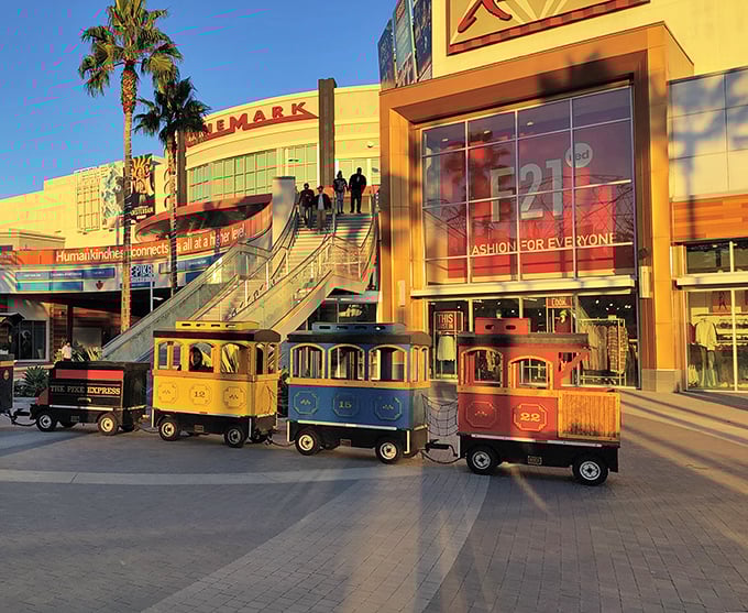 Colorful train cars line up like a children's parade, bringing whimsical charm to this shopping destination.
