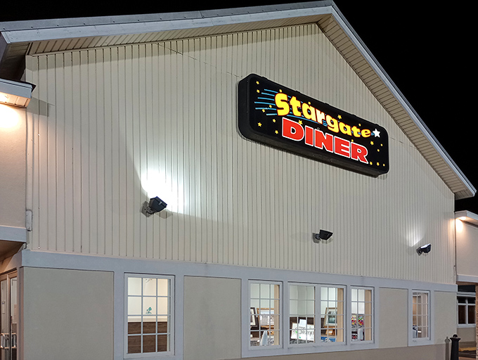 The iconic Stargate Diner sign glows like a beacon in the night, promising cosmic comfort food and those legendary fish and chips.