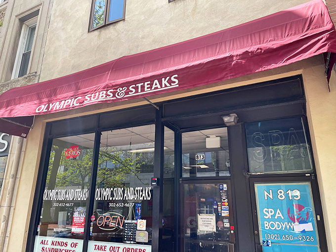 The iconic red awning of Olympic Subs & Steaks stands as a beacon of hope for the hungry on North Market Street. No frills, just sandwich thrills.