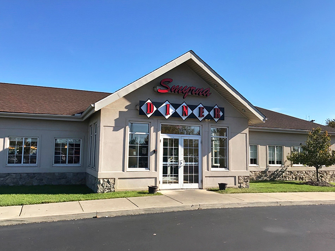 The classic red "DINER" sign beckons like a lighthouse for the hungry. Smyrna's exterior promises comfort food salvation in a modern building with timeless appeal.