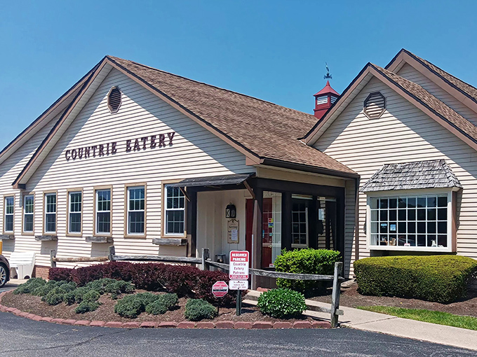 The cream-colored exterior of The Countrie Eatery stands proudly against a blue Delaware sky, promising homestyle comfort before you even step inside.