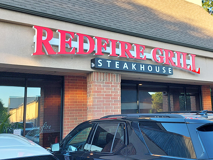 The bold red signage of Redfire Grill & Steakhouse stands out like a culinary lighthouse, beckoning hungry travelers to drop anchor in Hockessin.