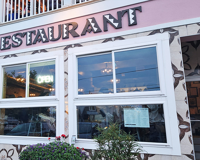 The pastel pink and mint green exterior of Mariachi Restaurant stands out like a cheerful beacon among Rehoboth's beachside buildings, promising authentic flavors within.