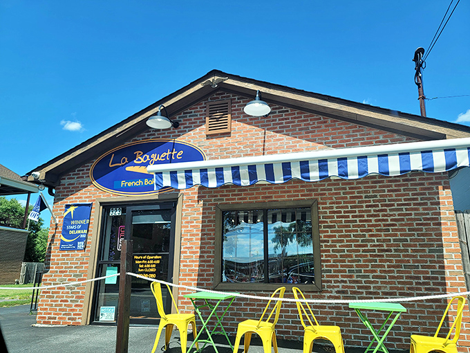 The charming brick exterior of La Baguette beckons like a Parisian postcard dropped into downtown Dover. That blue and white awning isn't just decoration&mdash;it's a promise of deliciousness.