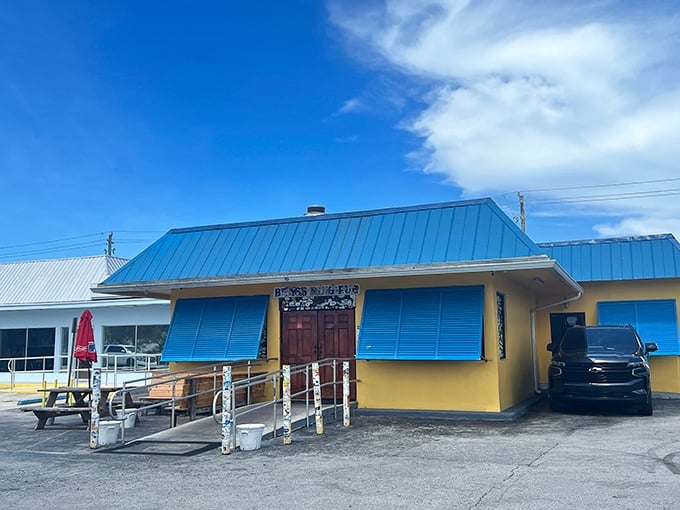 The unassuming yellow exterior with bright blue trim might fool you, but locals know this modest building houses wing perfection. Florida's best-kept culinary secret hides in plain sight.