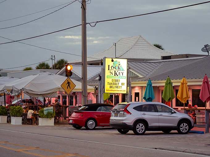 The pastel-pink exterior of Lock 'N Key glows like a Florida sunset, complete with colorful umbrellas that practically whisper "come sit a while" to passersby.