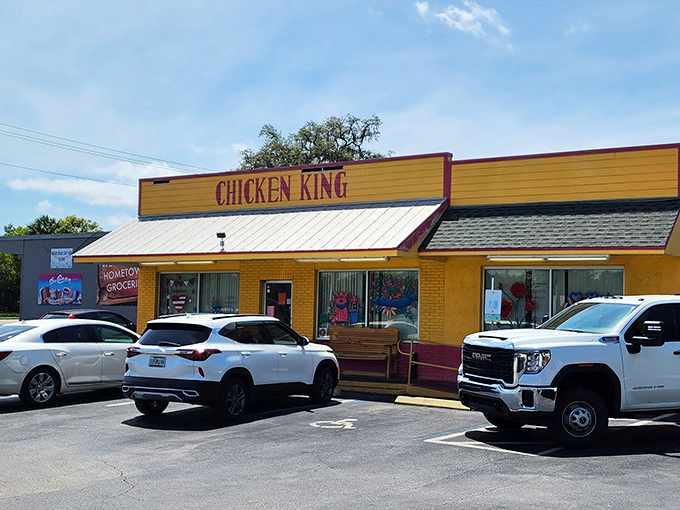 The bright orange exterior of Chicken King stands out like a culinary lighthouse, beckoning hungry travelers with its unmistakable promise of comfort food paradise.